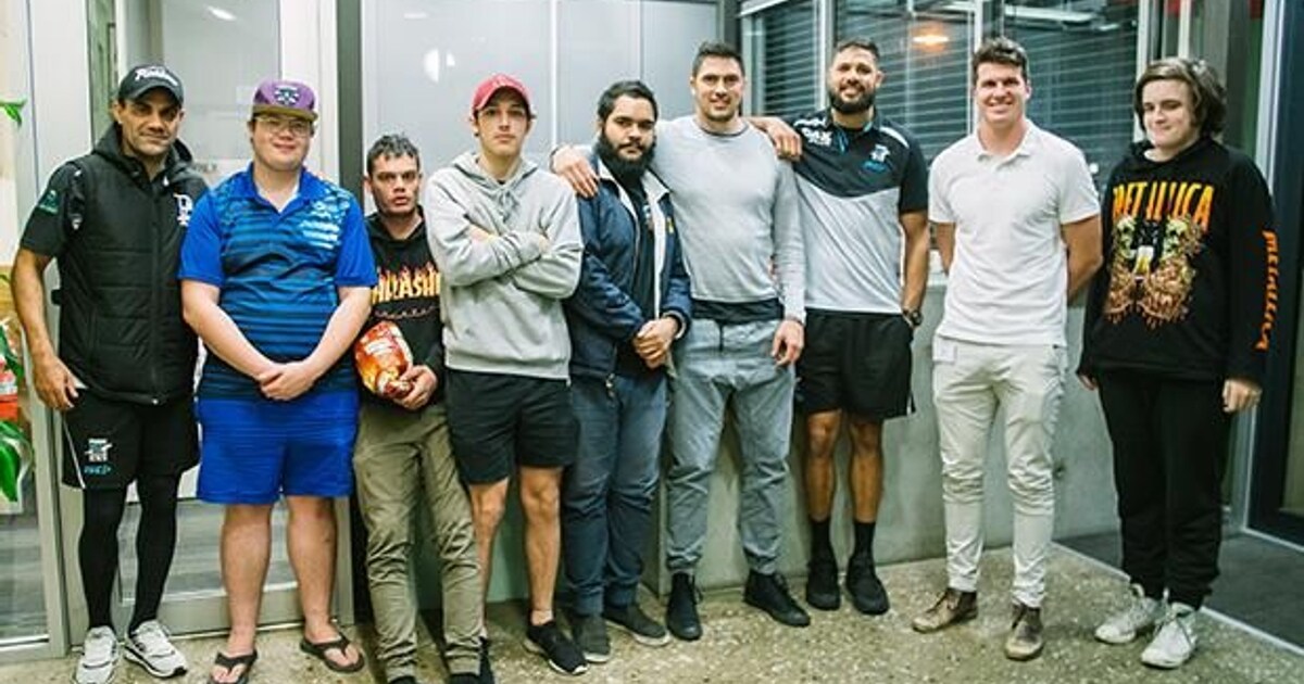 Port Adelaide players embrace Ladder